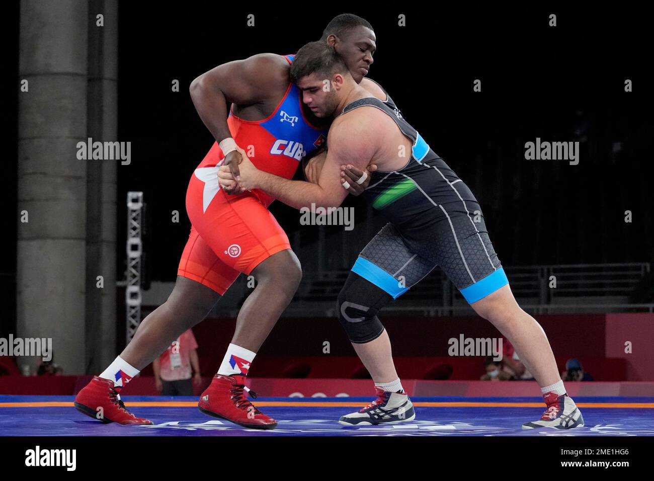 Cuba's Mijain Lopez Nunez, left, against Iran's Amin Mirzazadeh battle ...