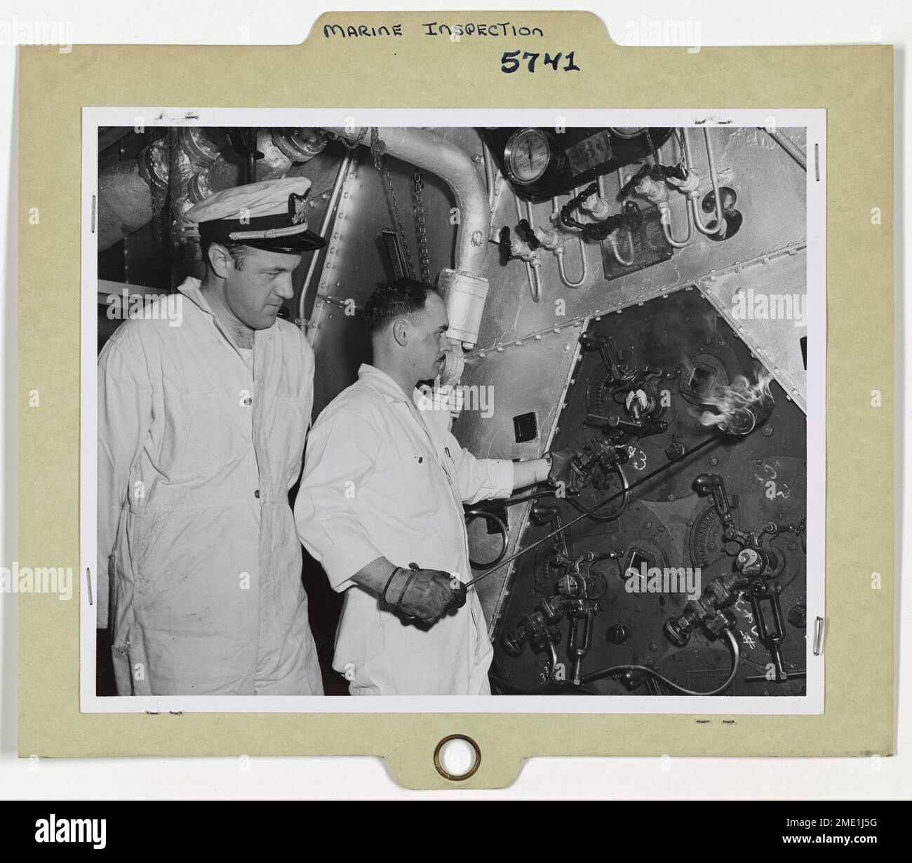 A U.S. Coast Guard inspector observes an ocean liner's engineer ...