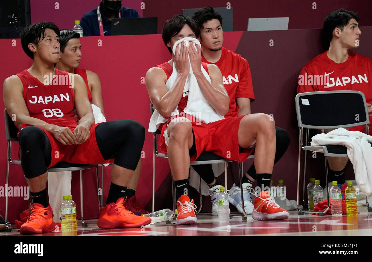 Japan's Daiki Tanaka (24), center, and teammates react after their loss ...