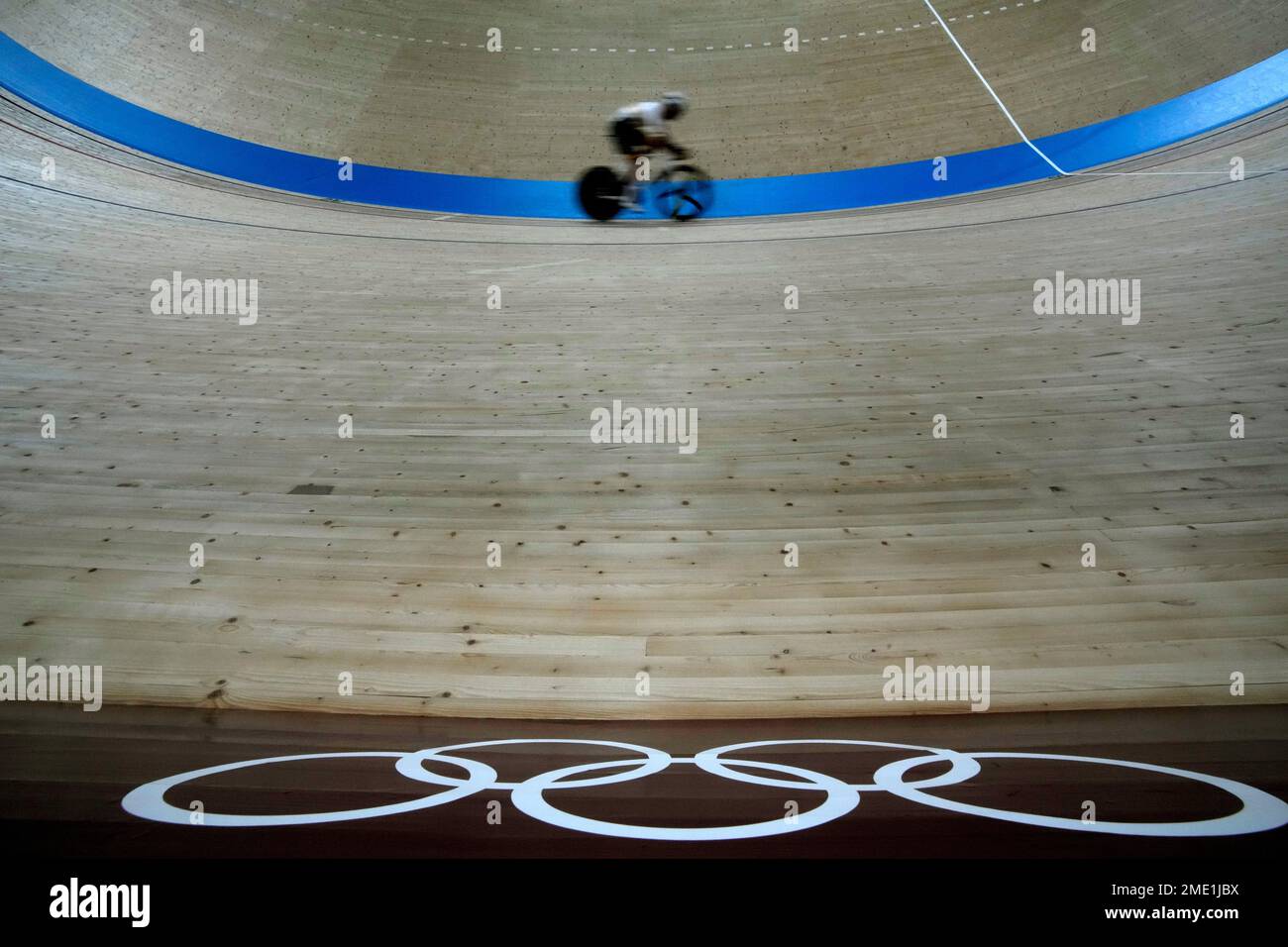 A riders rounds the track past Olympic Rings during a training session ...
