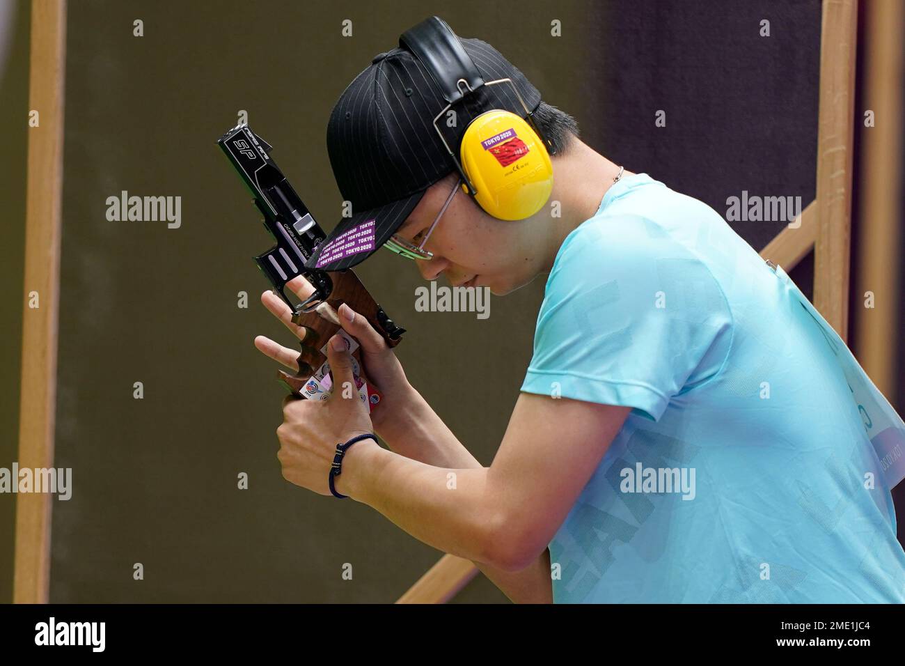Li Yuehong, of China, competes in the men's 25-meter rapid fire pistol ...
