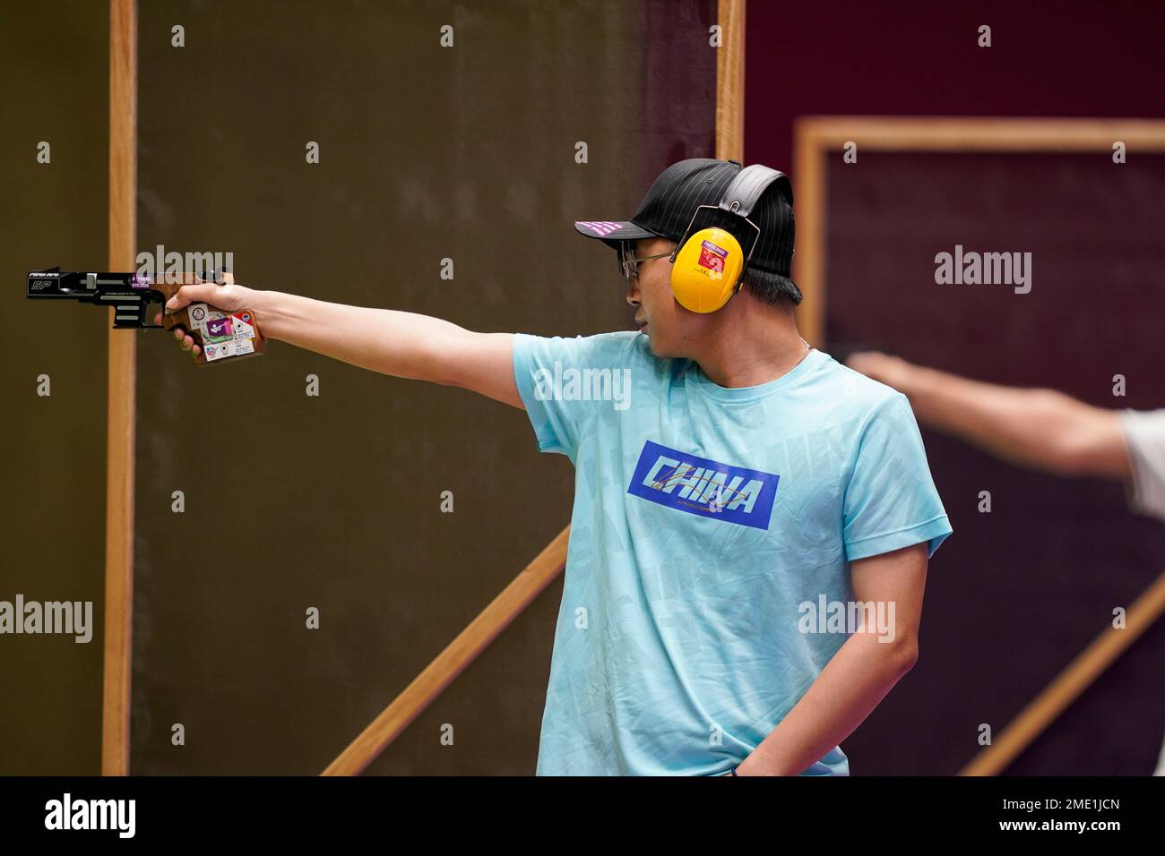 Li Yuehong, of China, competes in the men's 25-meter rapid fire pistol ...