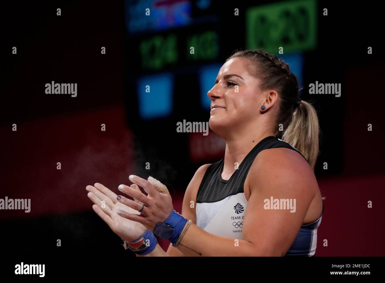 Emily Victoria Godley of Britain claps after a lift in the women's 76kg ...