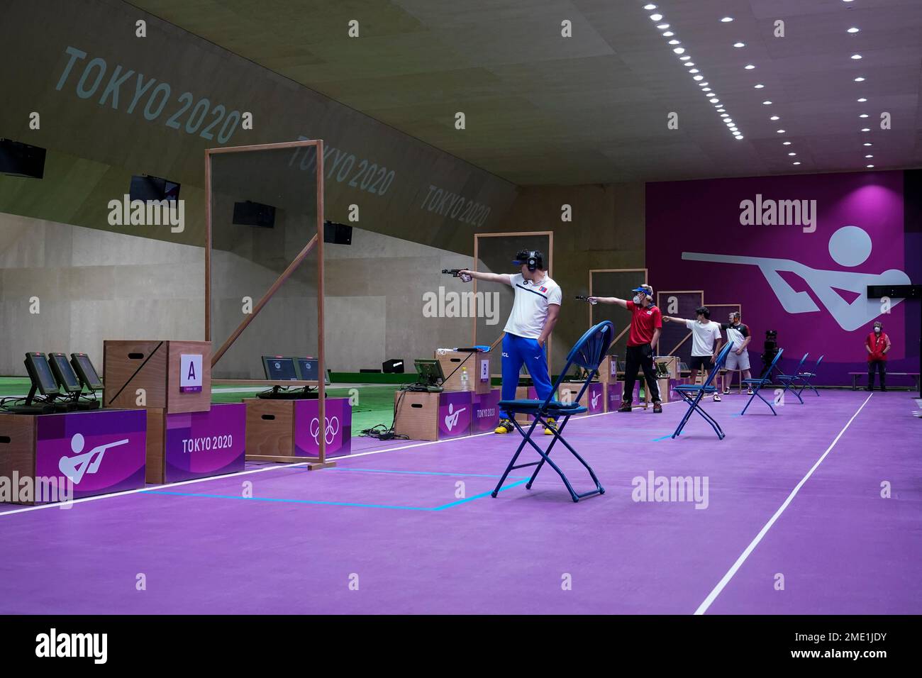 Athletes compete in the men's 25-meter rapid fire pistol at the Asaka ...
