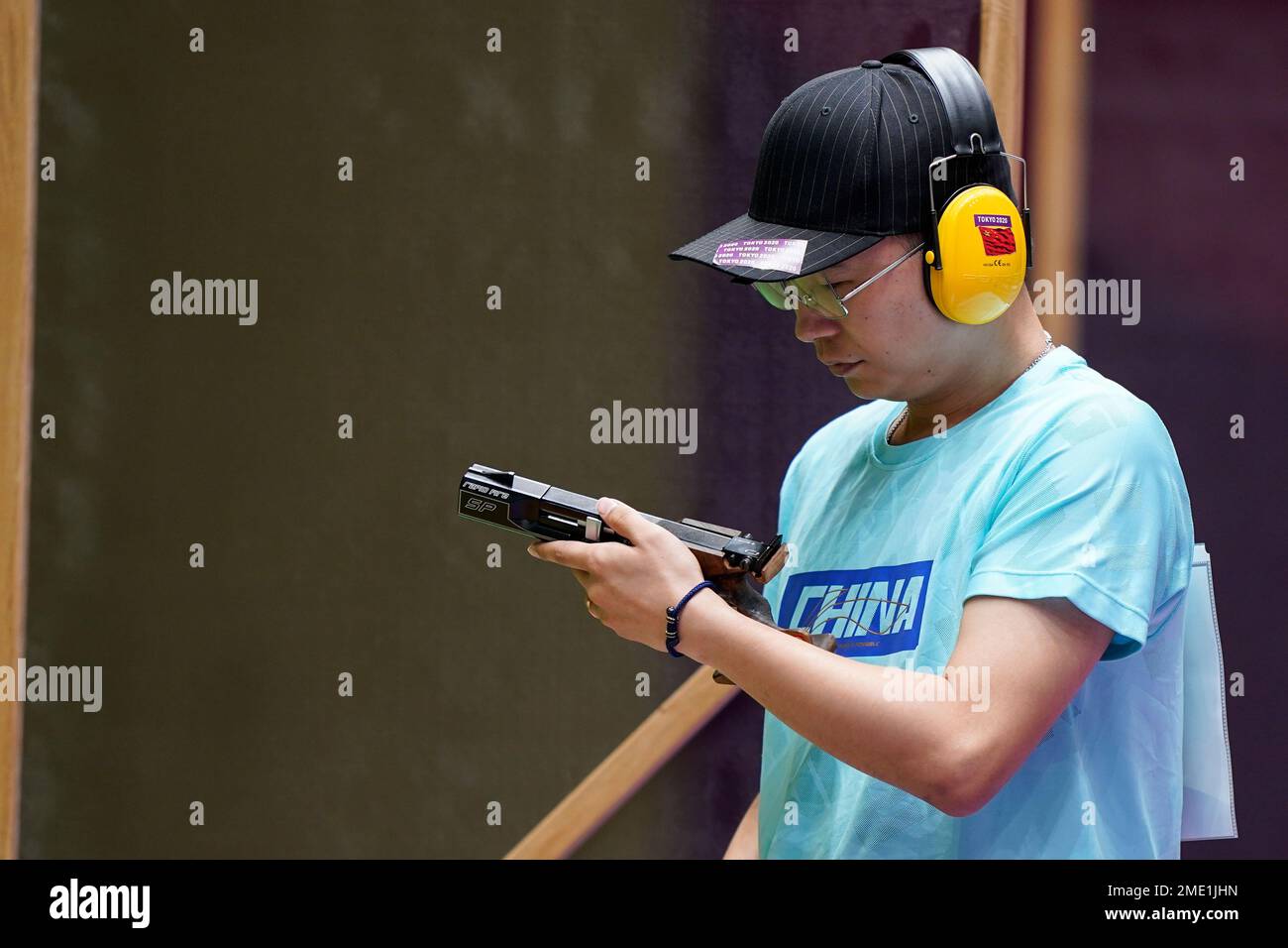 Li Yuehong, of China, competes in the men's 25-meter rapid fire pistol ...