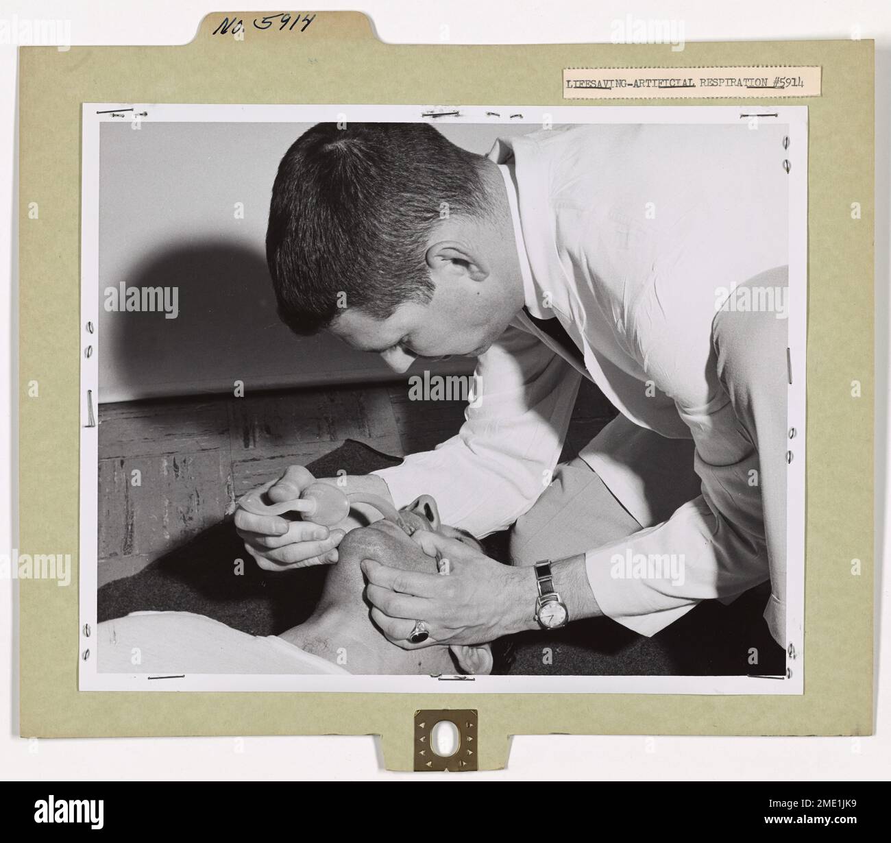 This image demonstrates the technique for mouth-to-mouth resuscitation ...