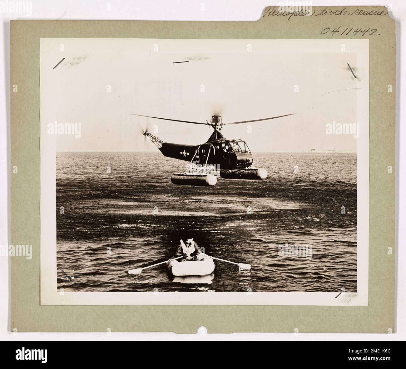 A Coast Guard pilot hovers above a distressed life raft to demonstrate ...