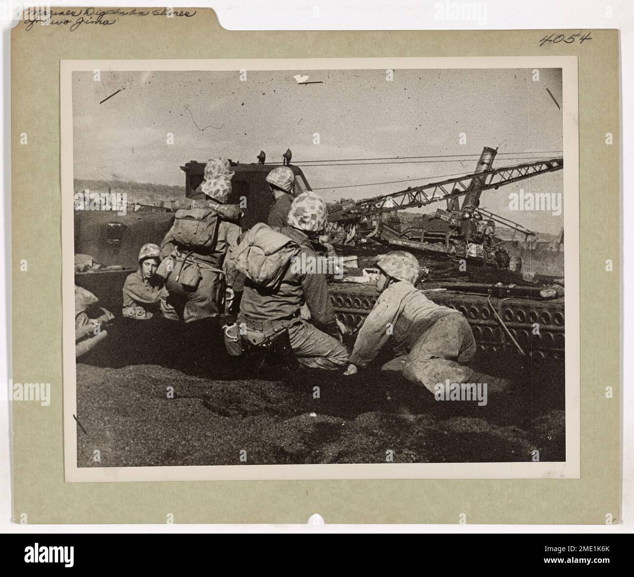 This image captures Marines from the first assault waves digging in and ...