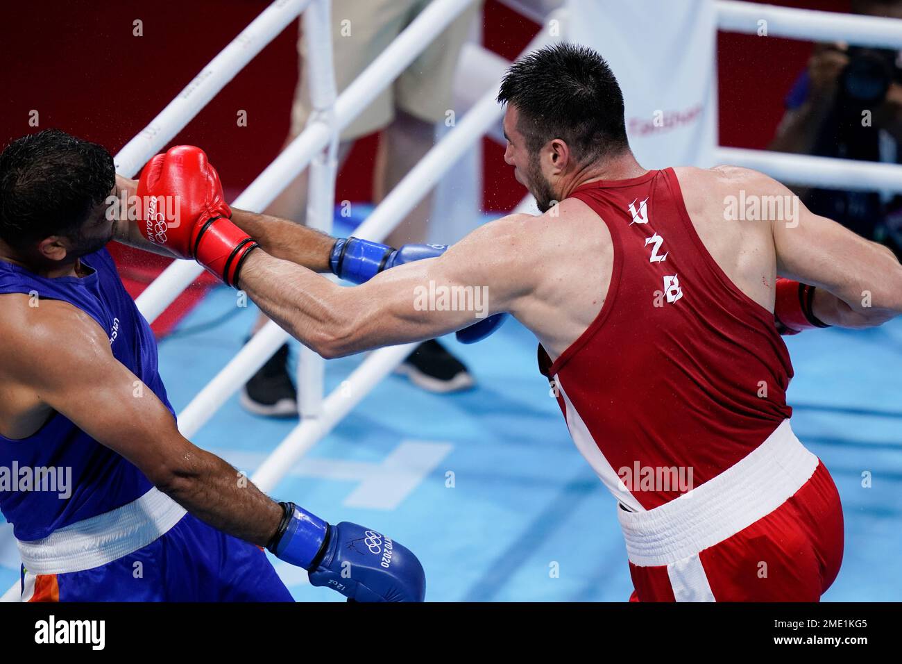 Uzbekistan's Bakhodir Jalolov, right, punches India's Satish Kumar ...
