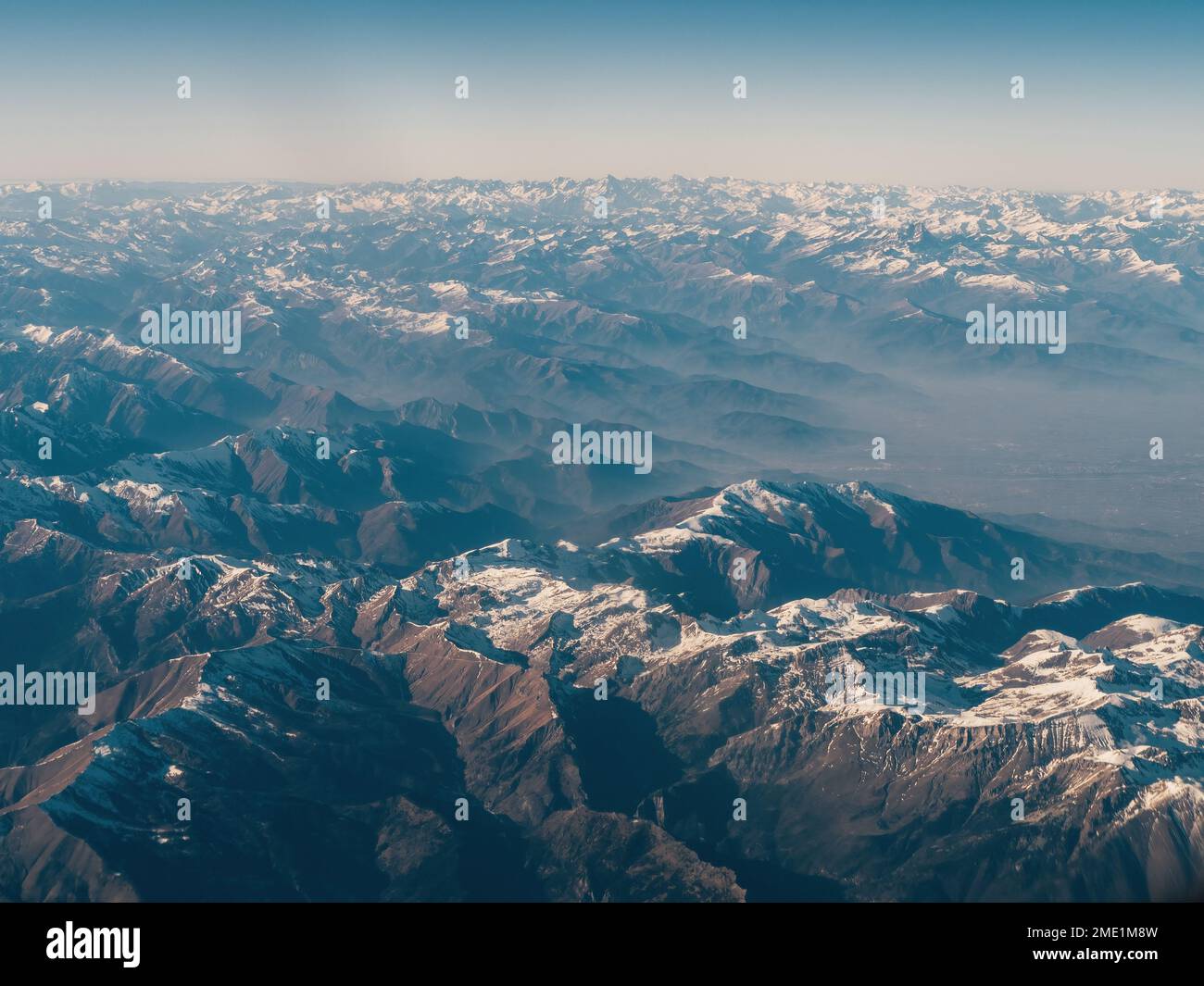 Mountain system of Alps stretches to horizon, slopes are covered with ...