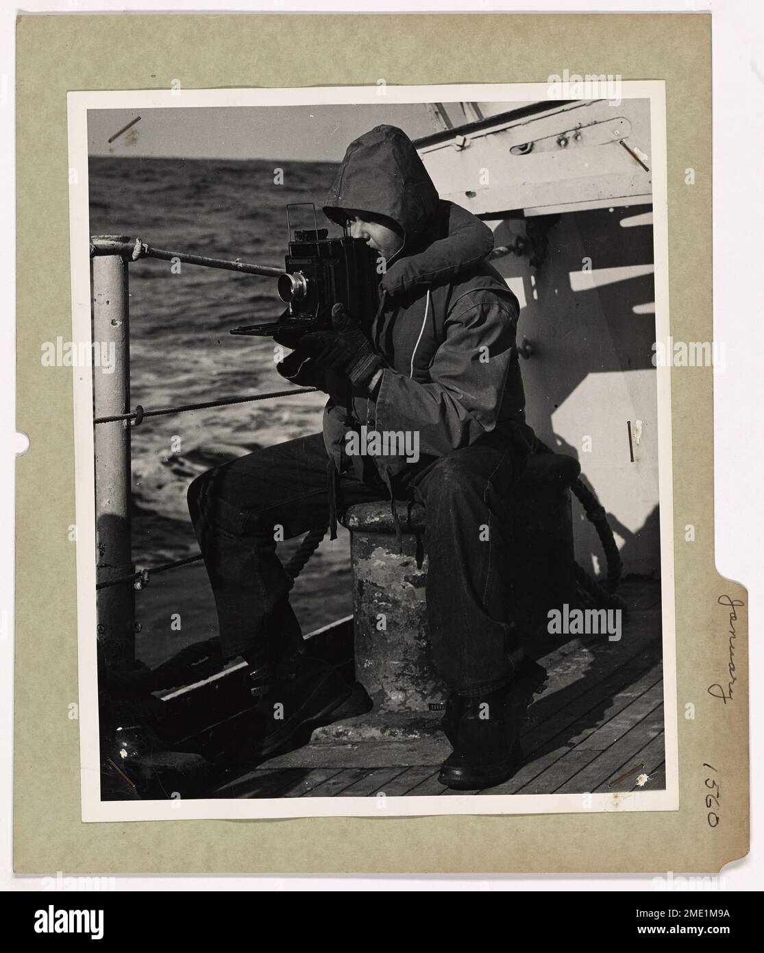 A U.S. Coast Guard combat photographer is shown in action, capturing ...