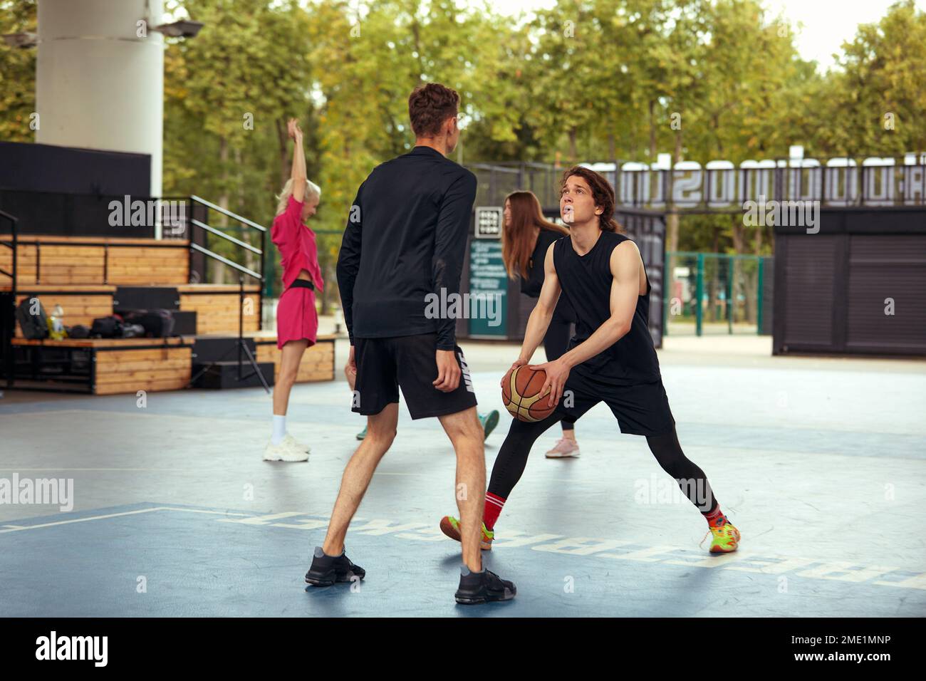Young guys playing basketball, posing for the camera on the city ...