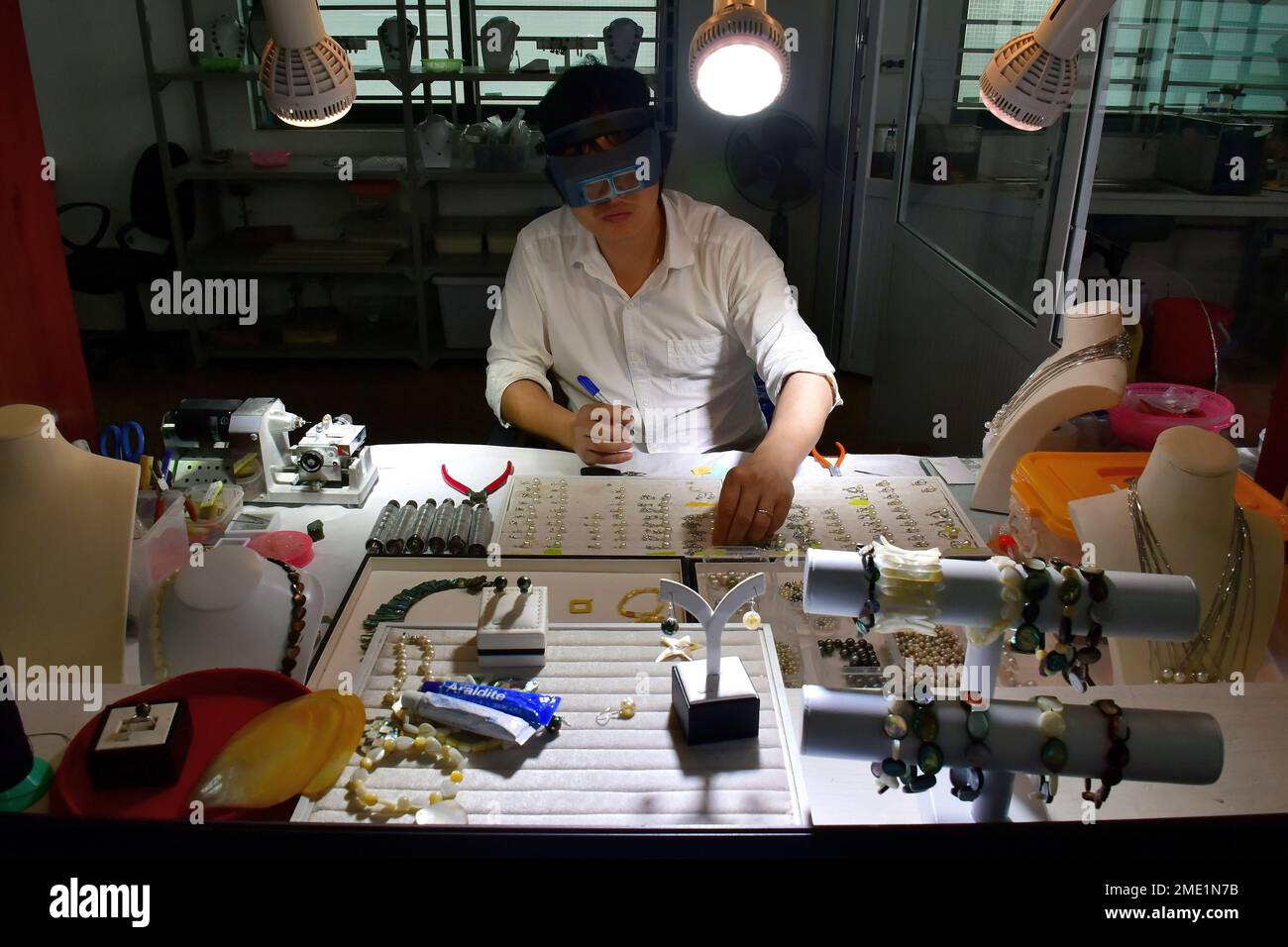 Vietnamese man making pearl jewellery, Pearl farm at Halong Bay ...