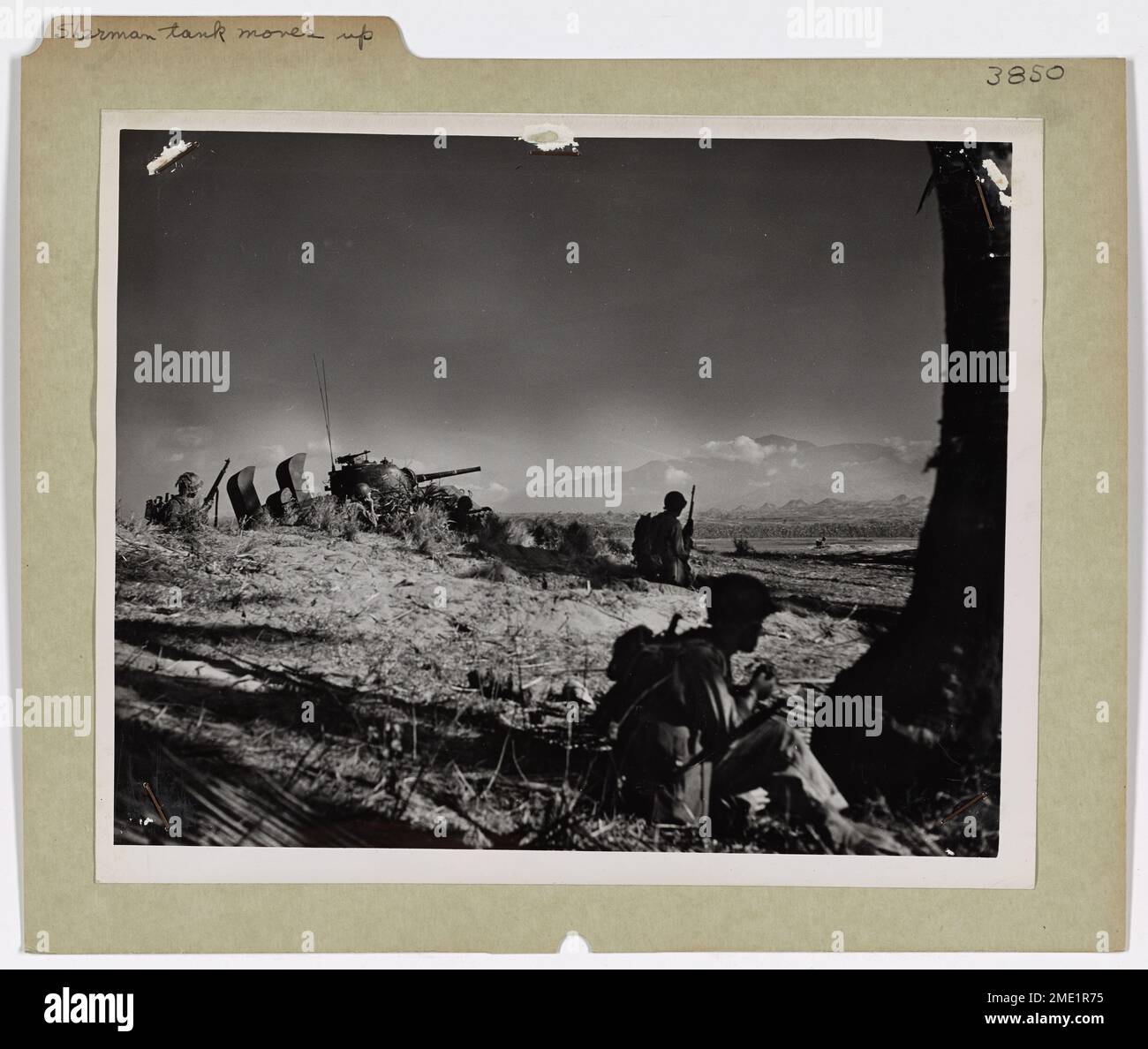 American troops advance with a Sherman tank from the Lingayen Gulf ...