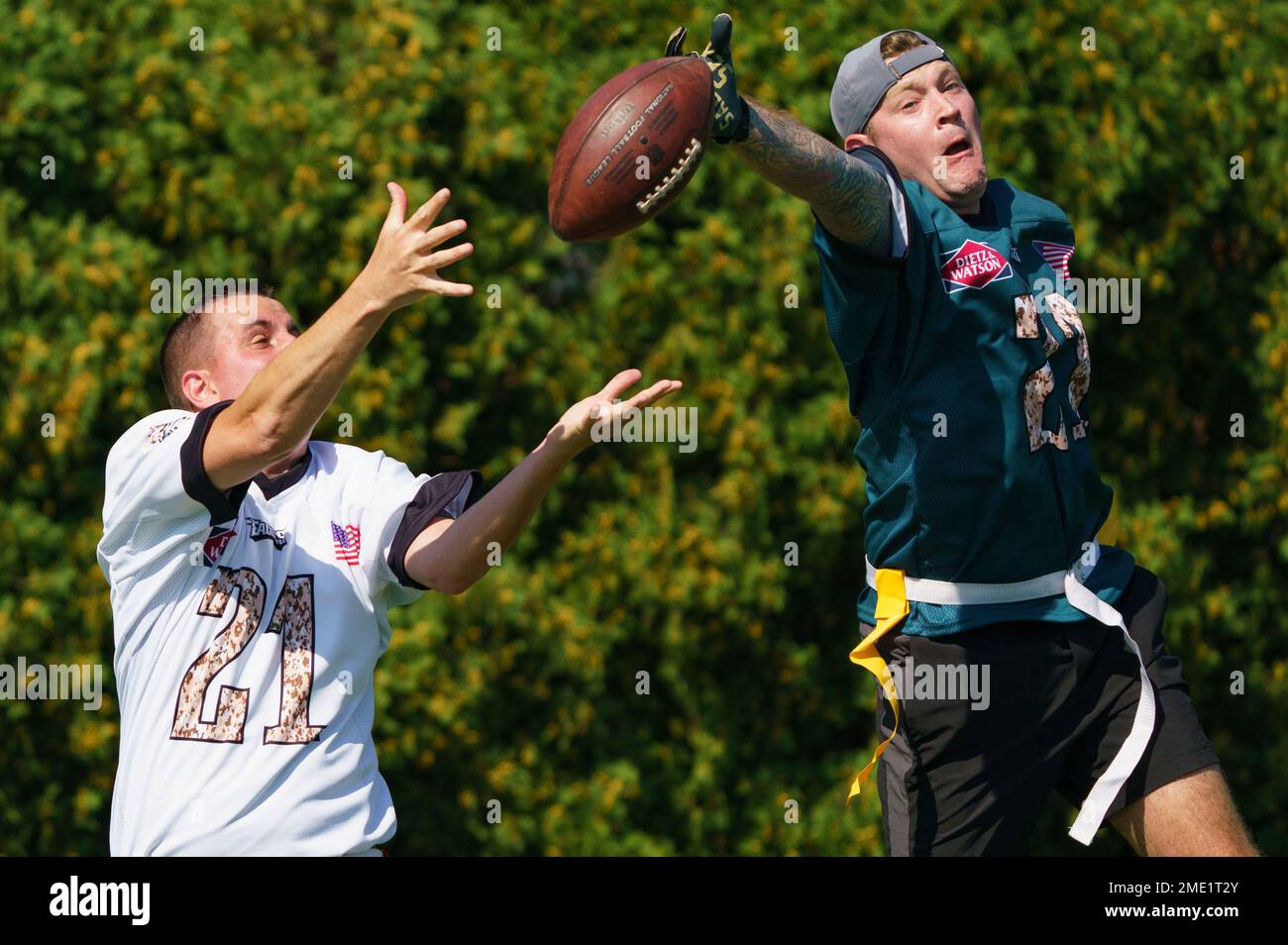 Members of the United States military play a game of flag football on ...