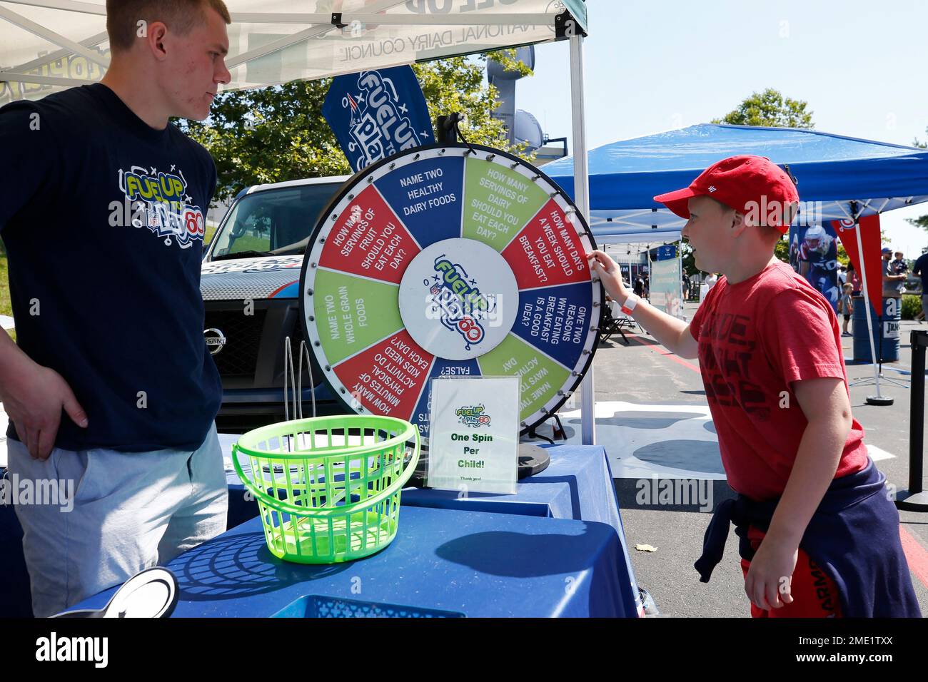 Children spin a wheel for a prize as part of Back Together Saturday ...