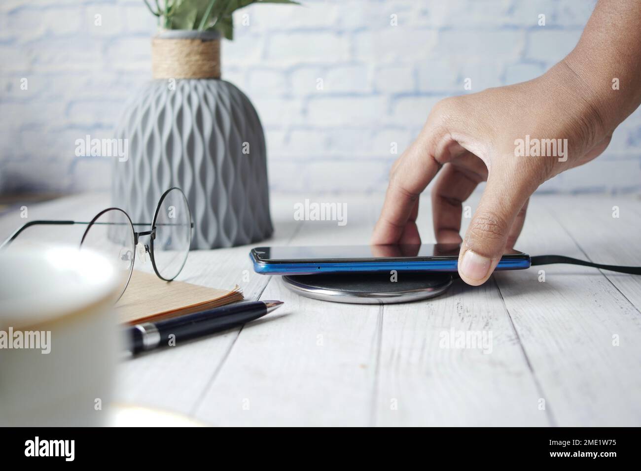 charging Smartphone using Wireless Charging Pad, top view Stock Photo ...