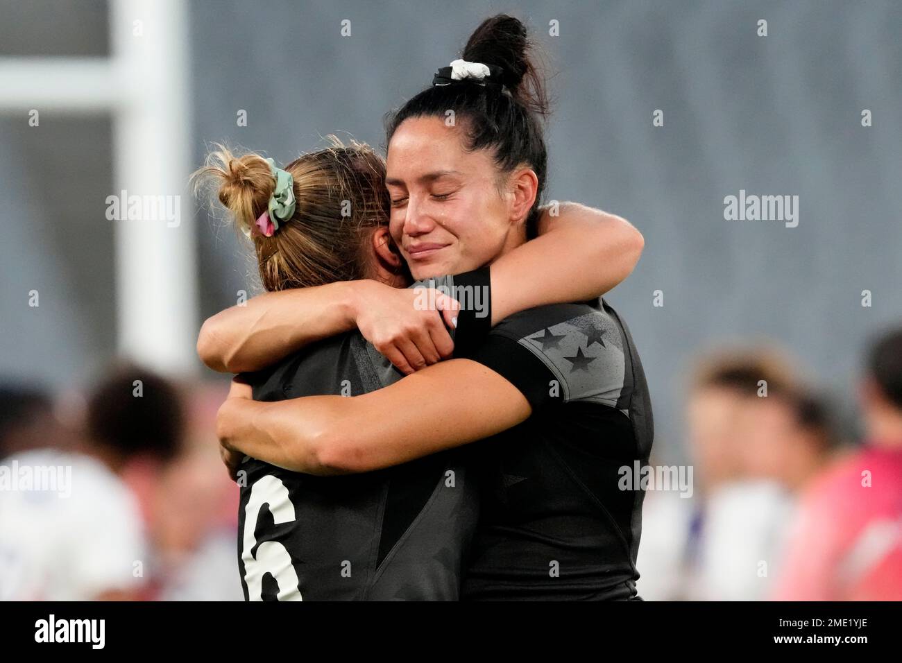A tear drops from New Zealand's Shiray Kaka, right, as she hugs ...