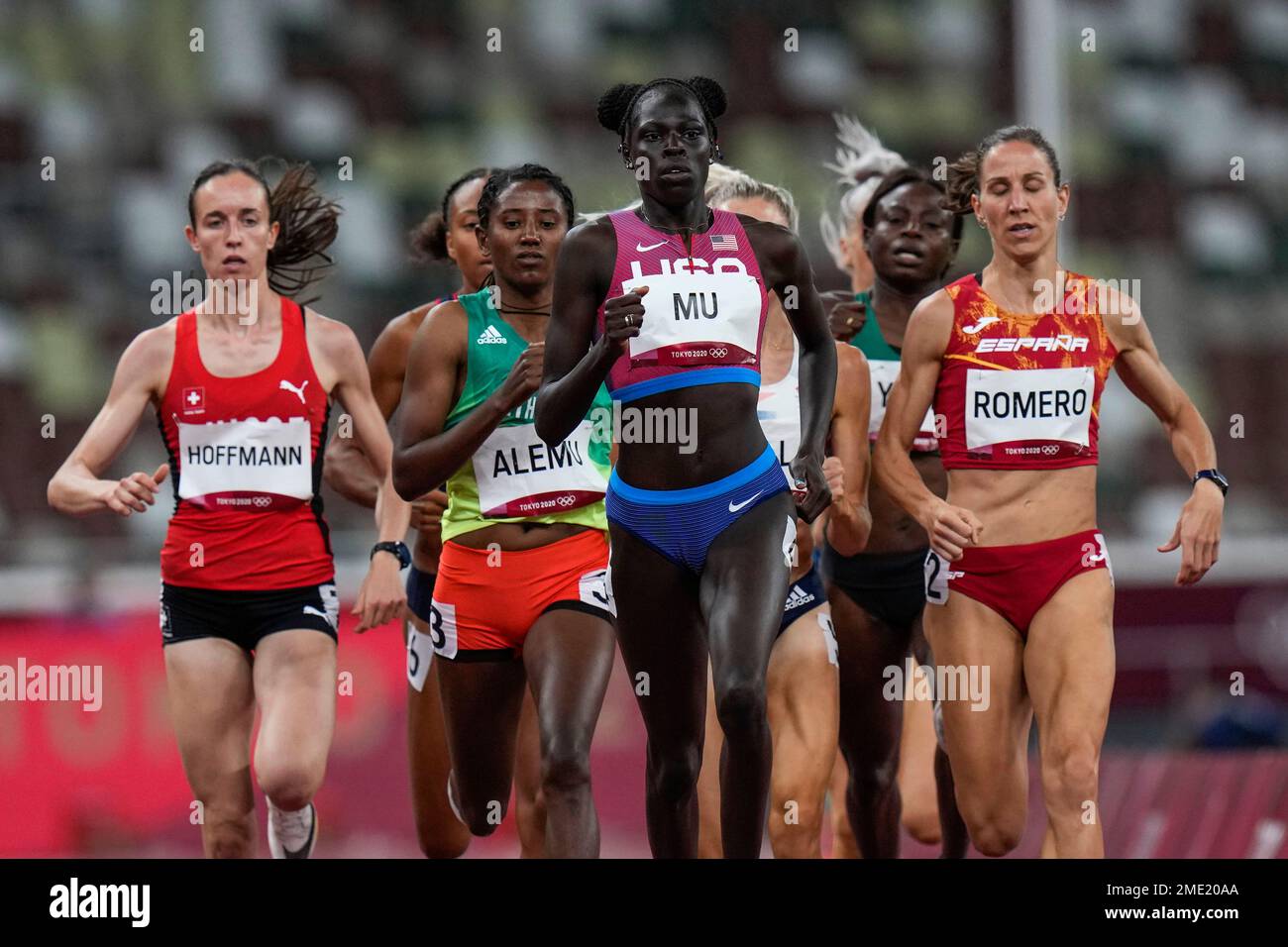 Athing Mu, of United States, center, wins a semifinal in the women's ...