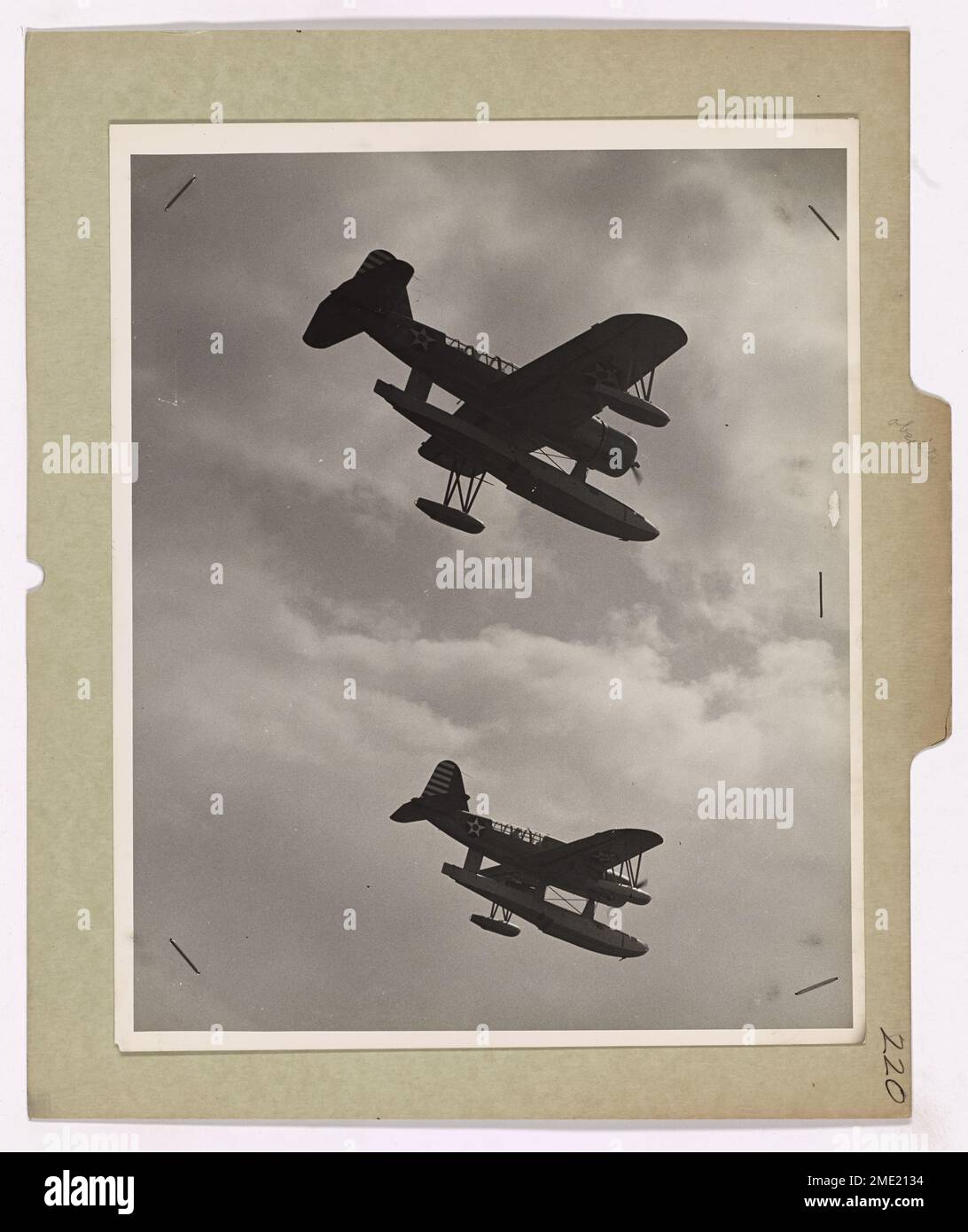 This image depicts two OS2U aircraft in flight. The OS2U, a versatile ...