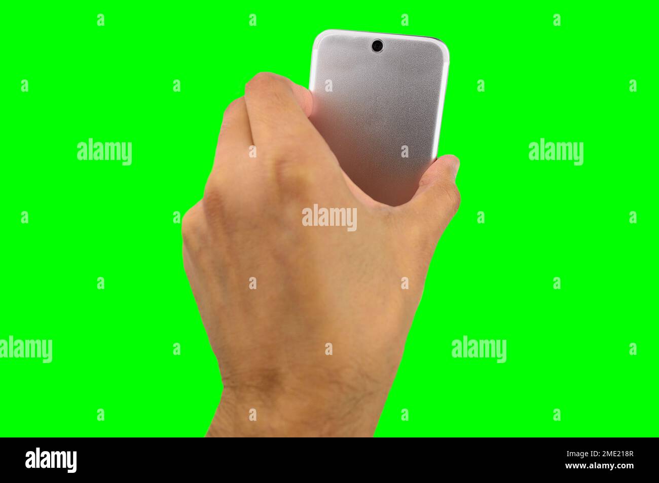A hand holding up a back smart phone with a isolated cutout on green ...