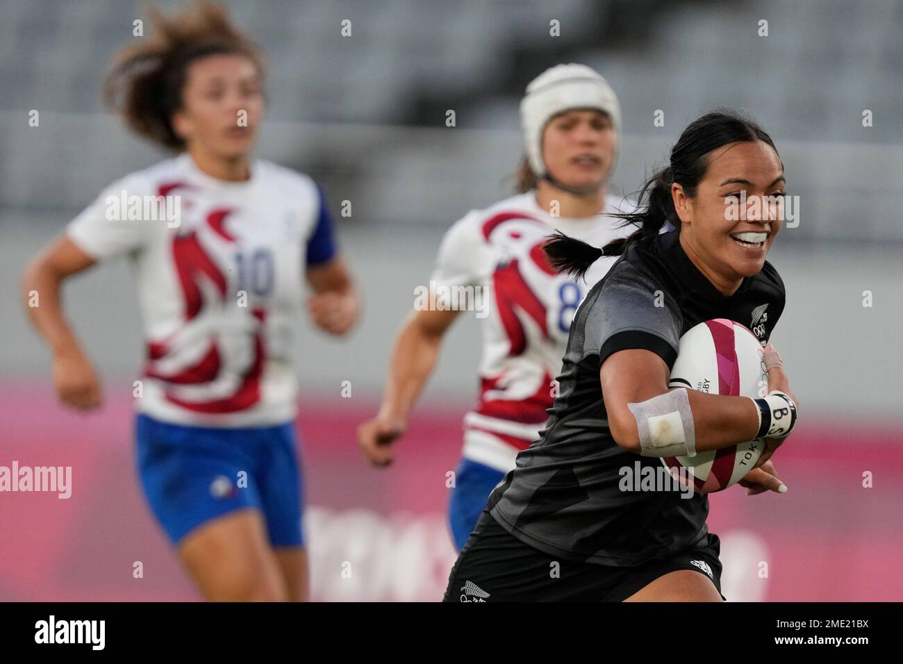 New Zealand's Stacey Fluhler, right, gets past France's Caroline Drouin ...