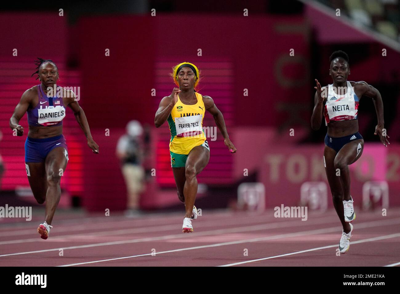 Shelly-Ann Fraser-Pryce, of Jamaica, center, wins a women's 100-meter semifinal at the 2020 ...