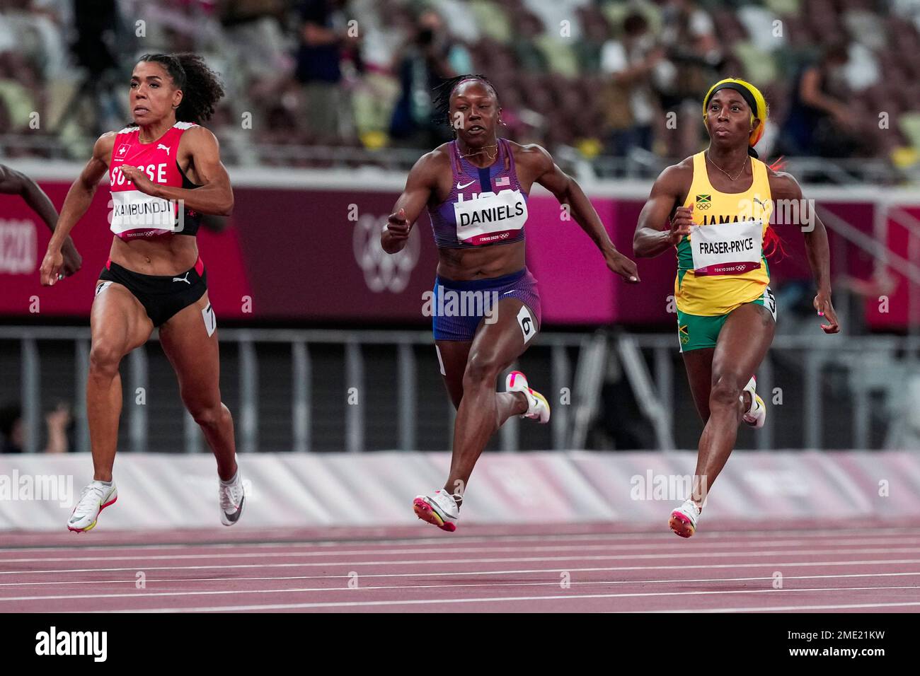 Shelly Ann Fraser Pryce Of Jamaica Right Wins A Womens 100 Meter