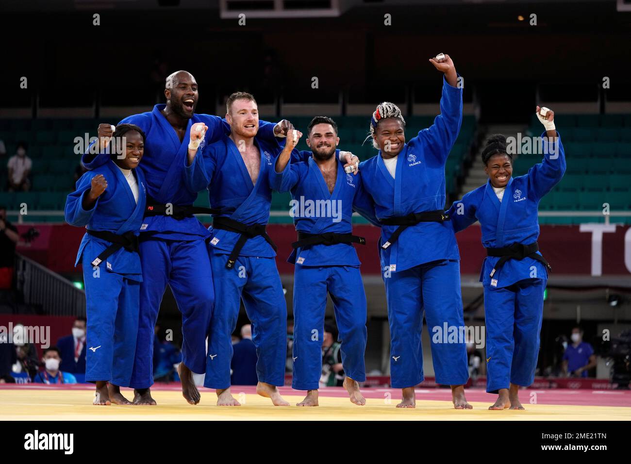 Members of the French team celebrate after defeating Japan in their ...