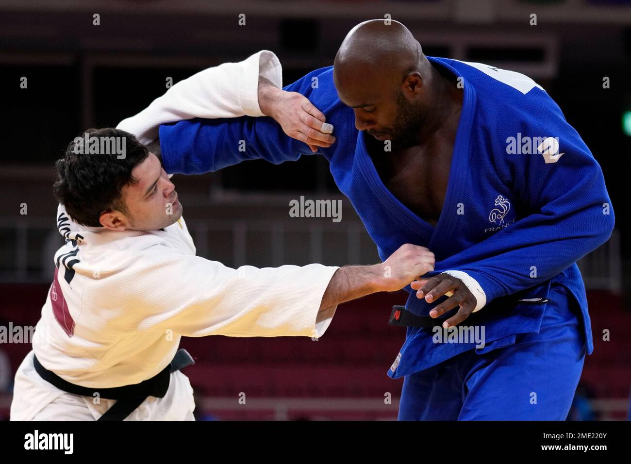 Aaron Wolf of Japan, left, and Teddy Riner of France compete during ...
