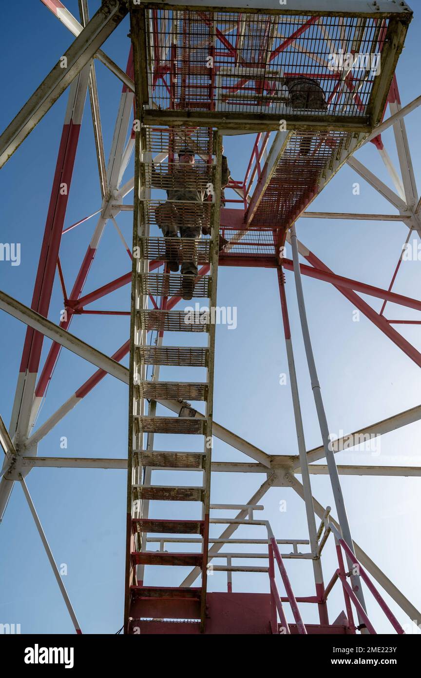 U.S. Air Force Airmen climb the stairs of an observation tower at Pine ...