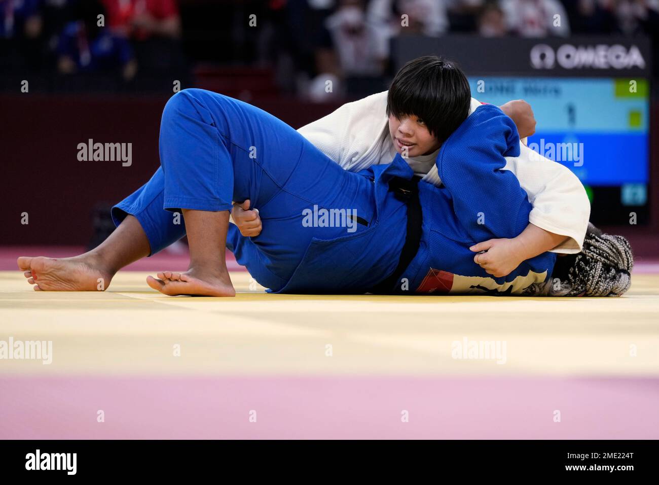Akira Sone of Japan, top, and Romane Dicko of France compete during ...
