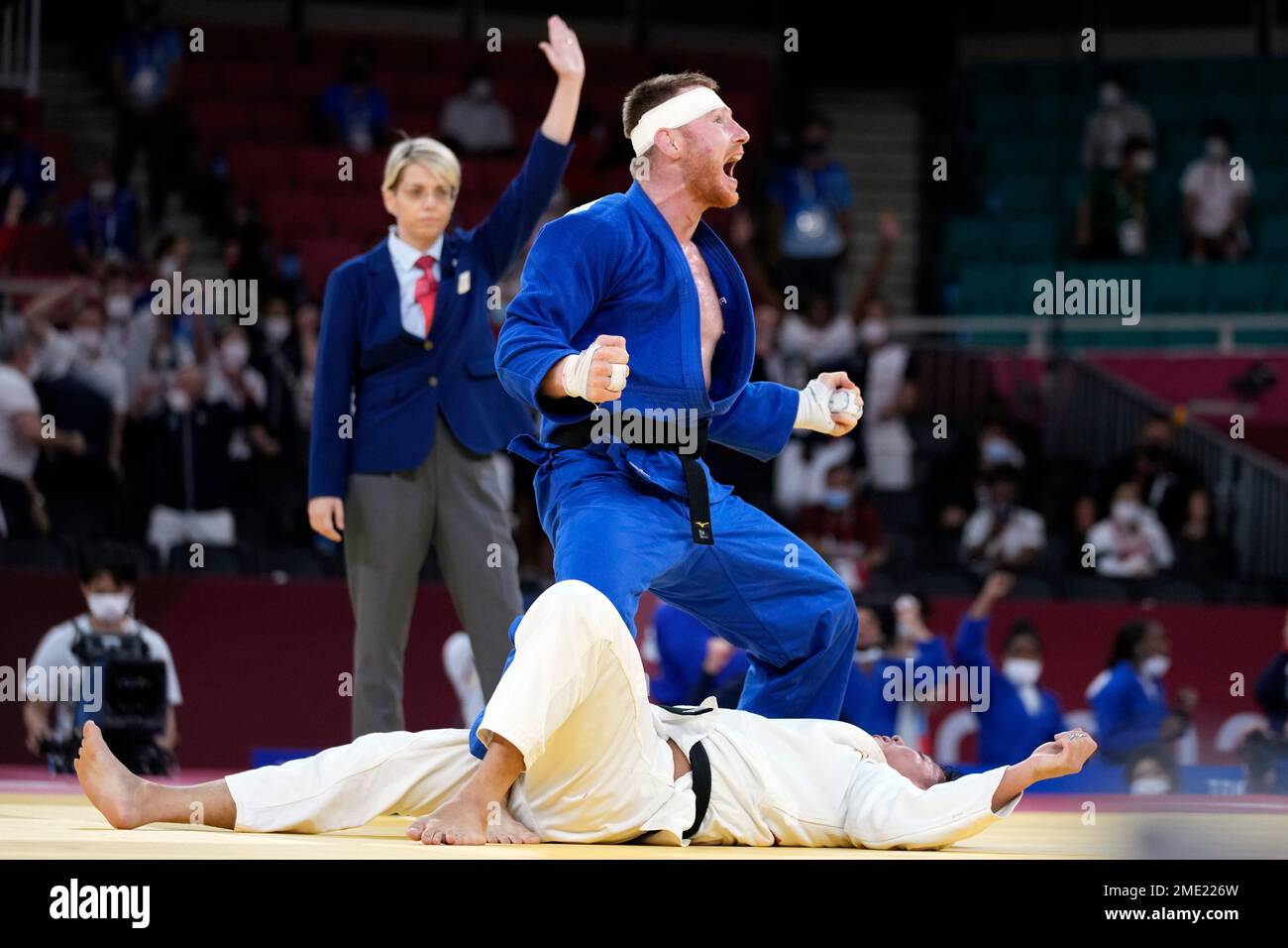 Axel Clerget of France, top, reacts after competing against Shoichiro ...