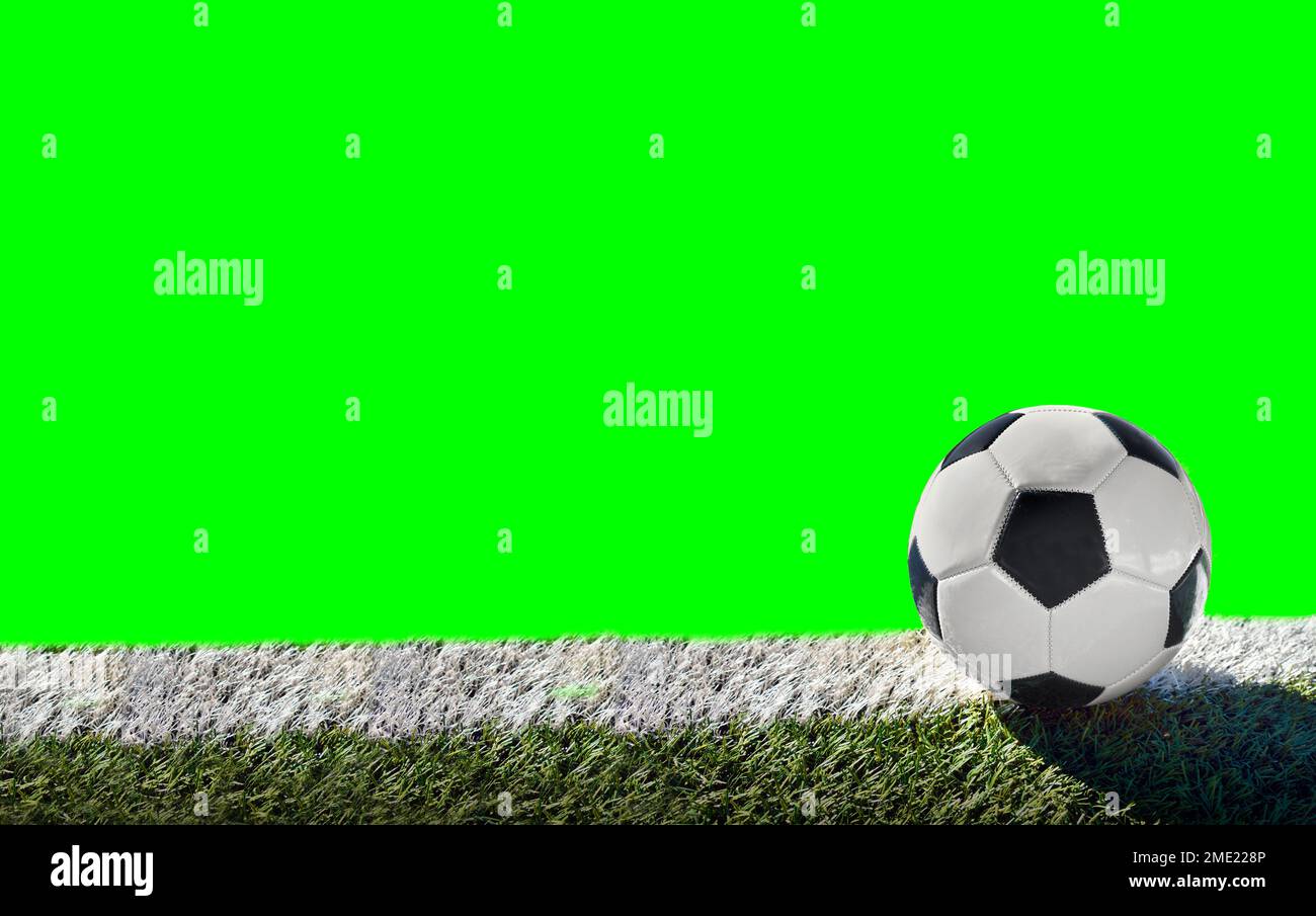 Soccer ball on grass field isolated cutout on green background with ...