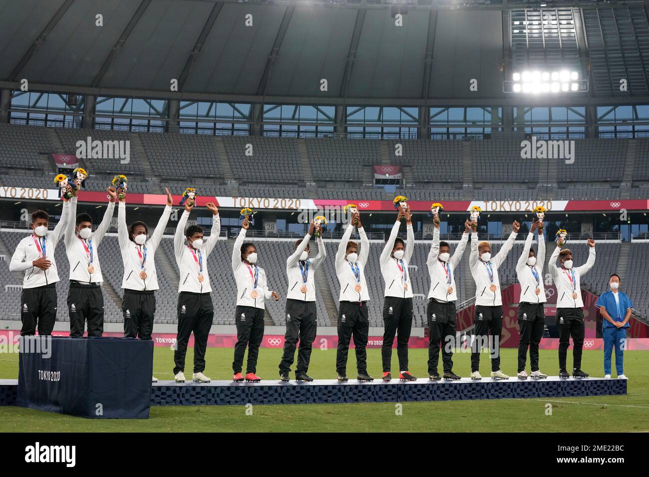 Fiji players wave after receiving their bronze medals in women's rugby ...