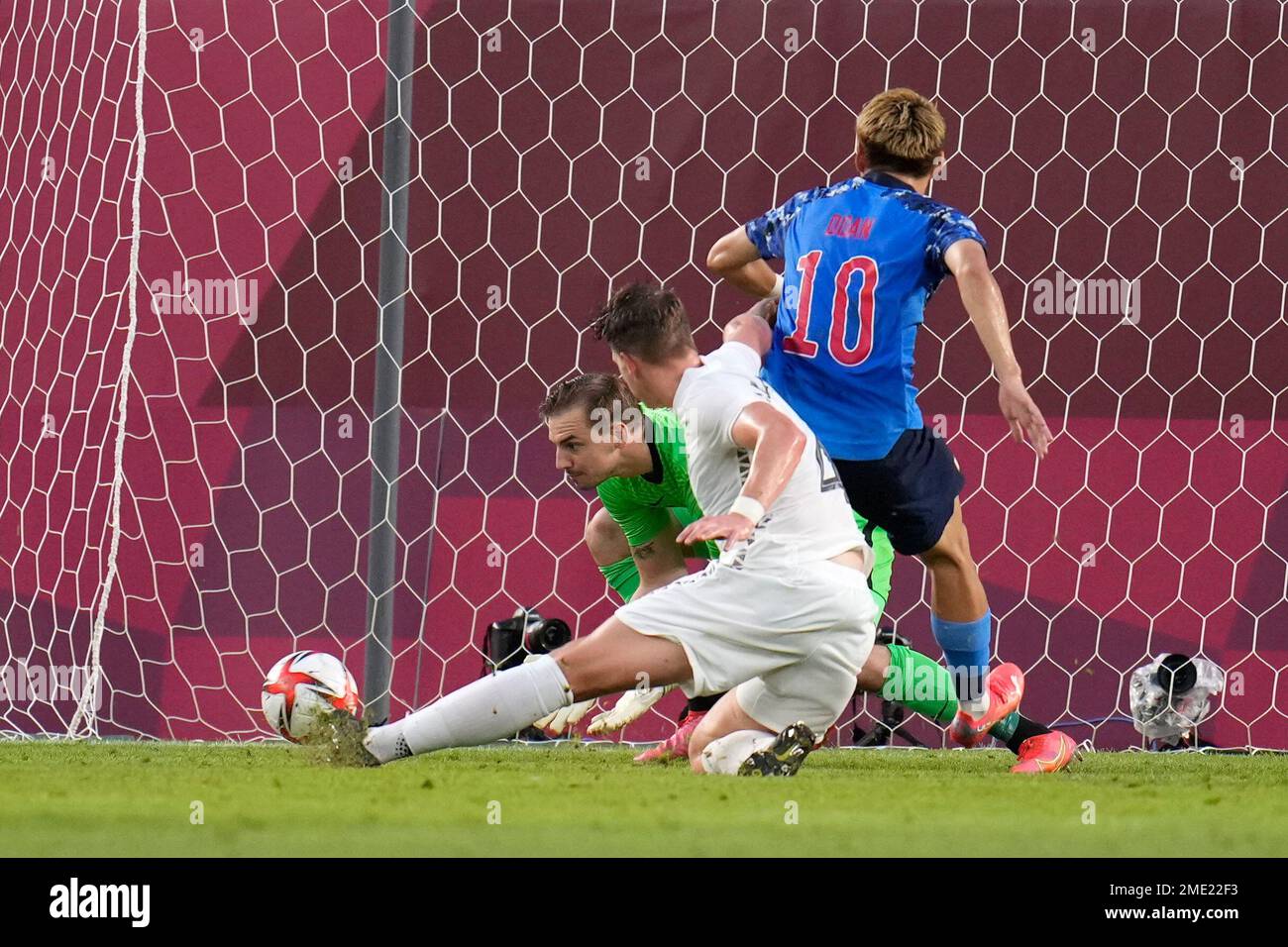 New Zealand's goalkeeper Michael Woud, left, eyes a shot by Japan's ...