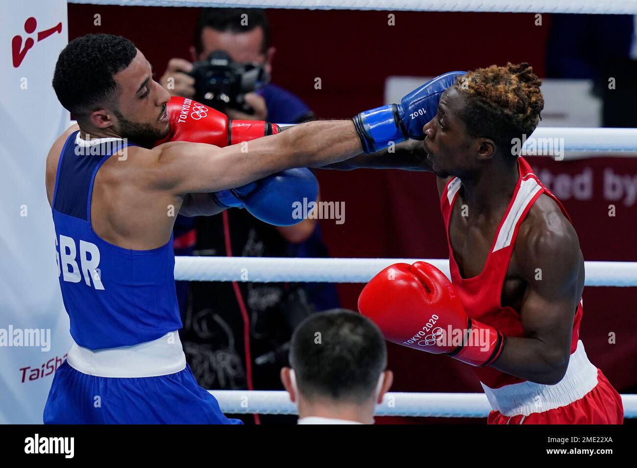 Zambia's Patrick Chinyemba, right exchanges punches with Britain's Galal Yafai during their men ...