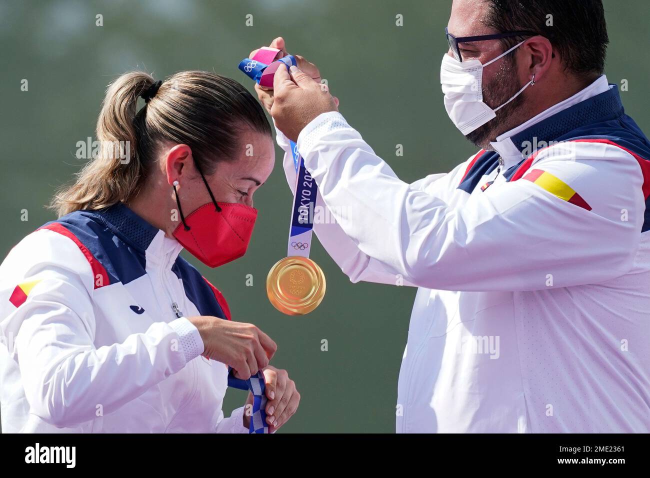 Fatima Galvez, left, receives her gold medal from Alberto Fernandez ...