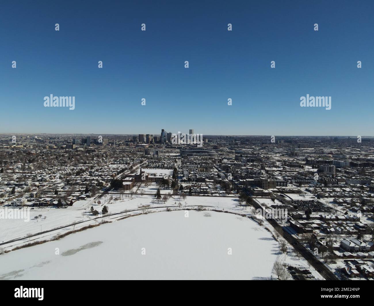 An aerial shot of the modern cityscape of Denver covered in snow in ...