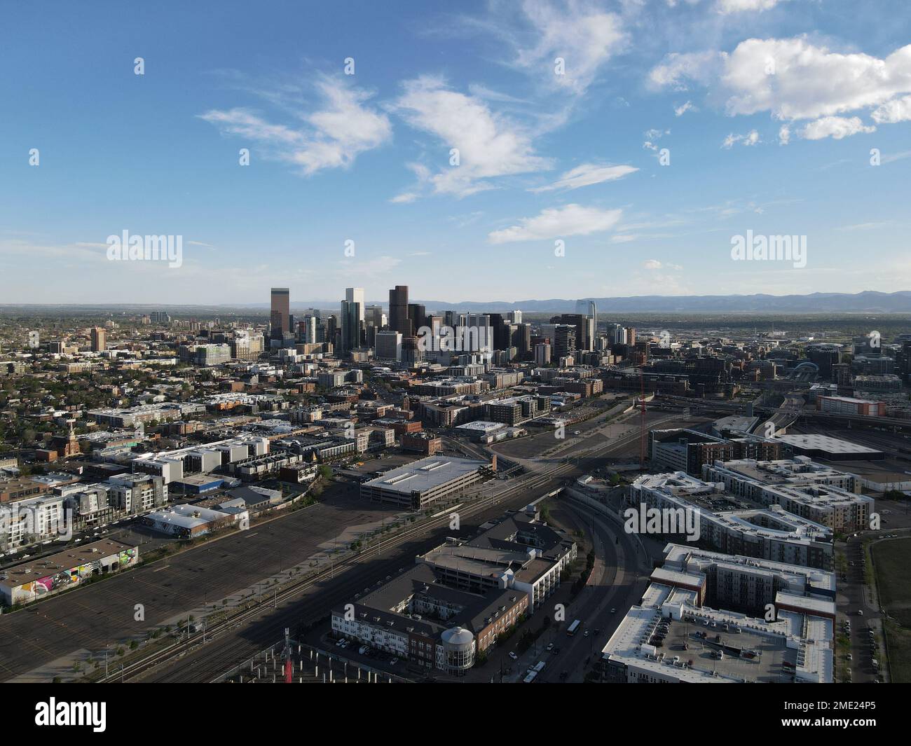 An aerial shot of the modern cityscape of Denver under the blue cloudy ...