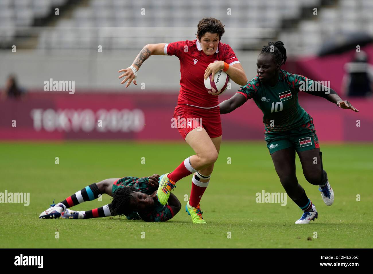 Canada's Britt Benn, center, is chased by Kenya's Grace Okulu, right ...