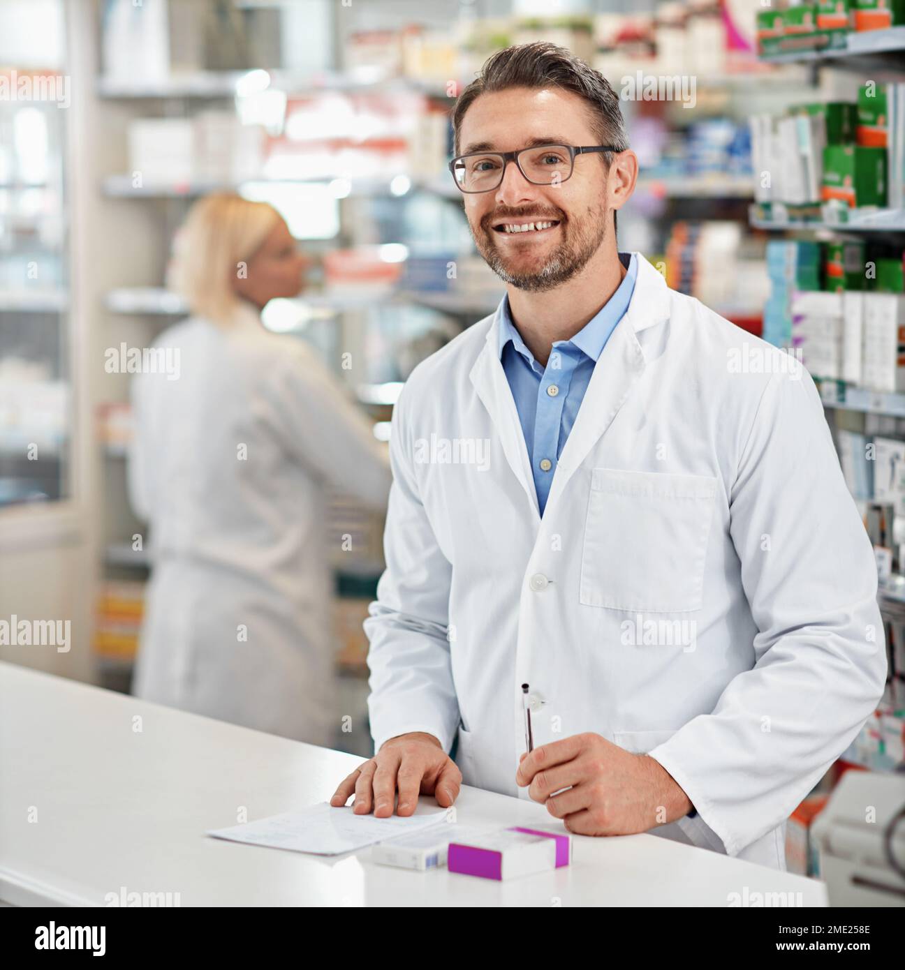 Portrait, service and pharmacist man at counter for medicine help ...