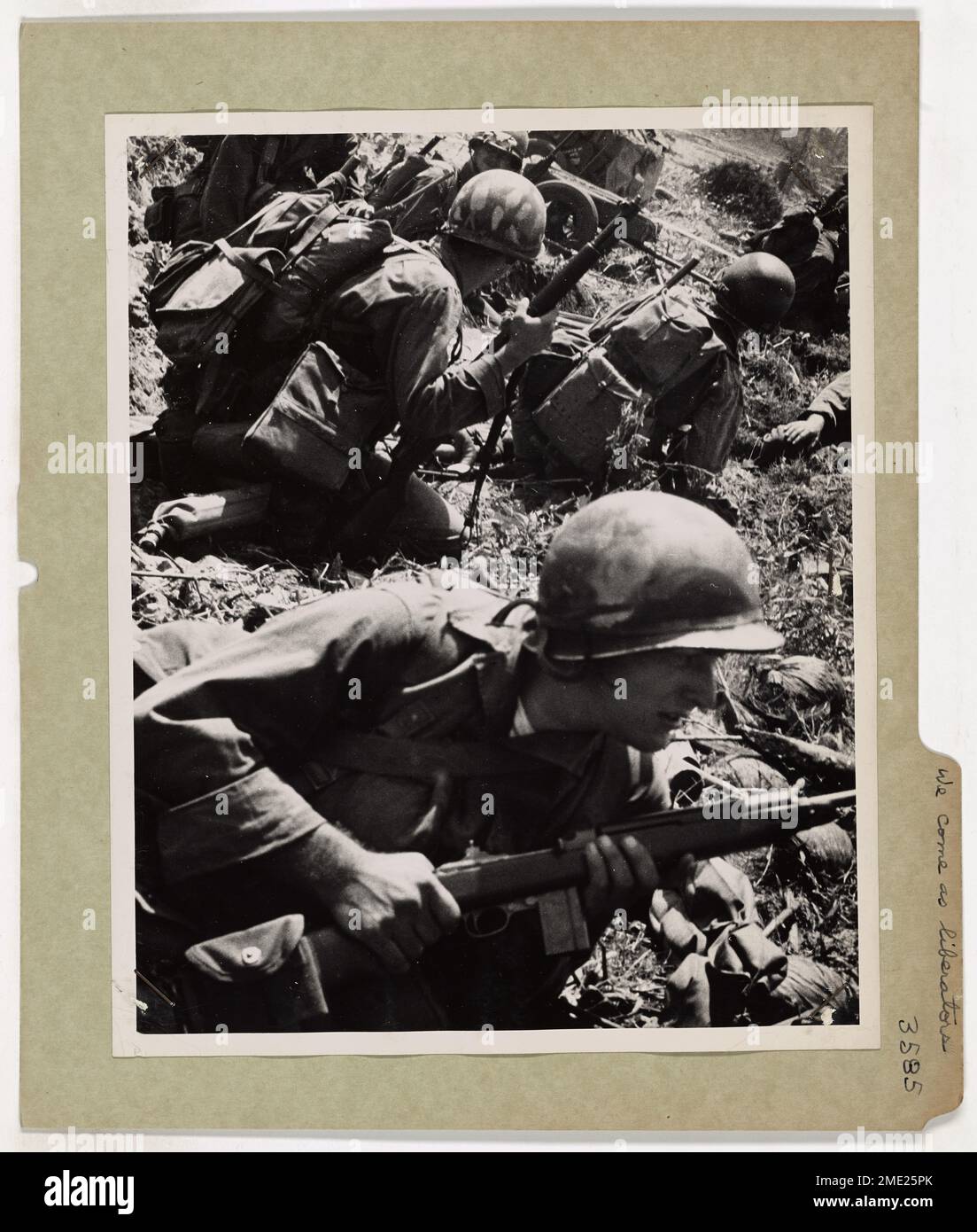 We Come as Liberators. American fighting men crouch low under a blanket ...