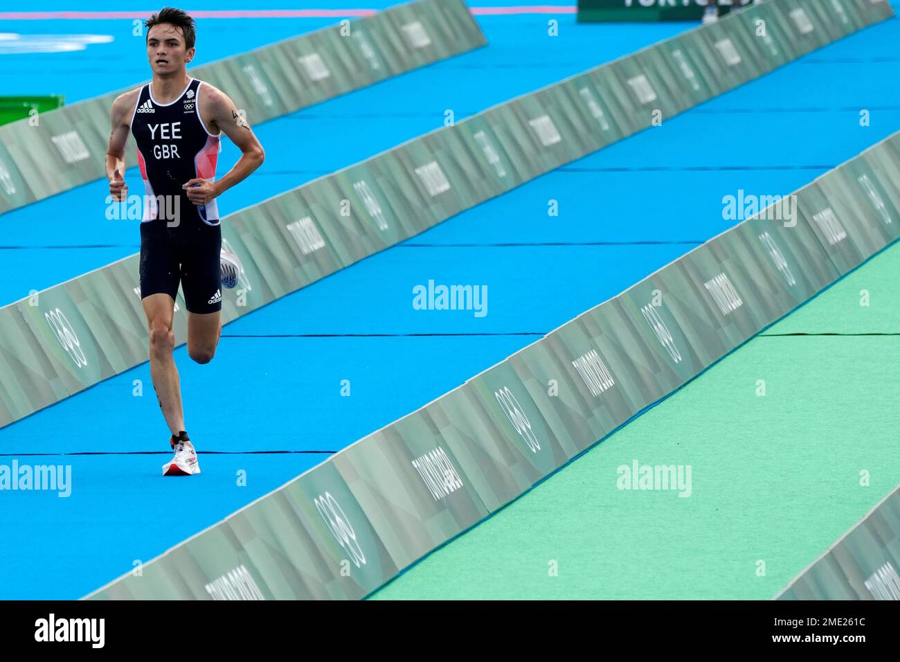 Alex Yee, of Britain, runs as he competes the mixed relay triathlon at ...