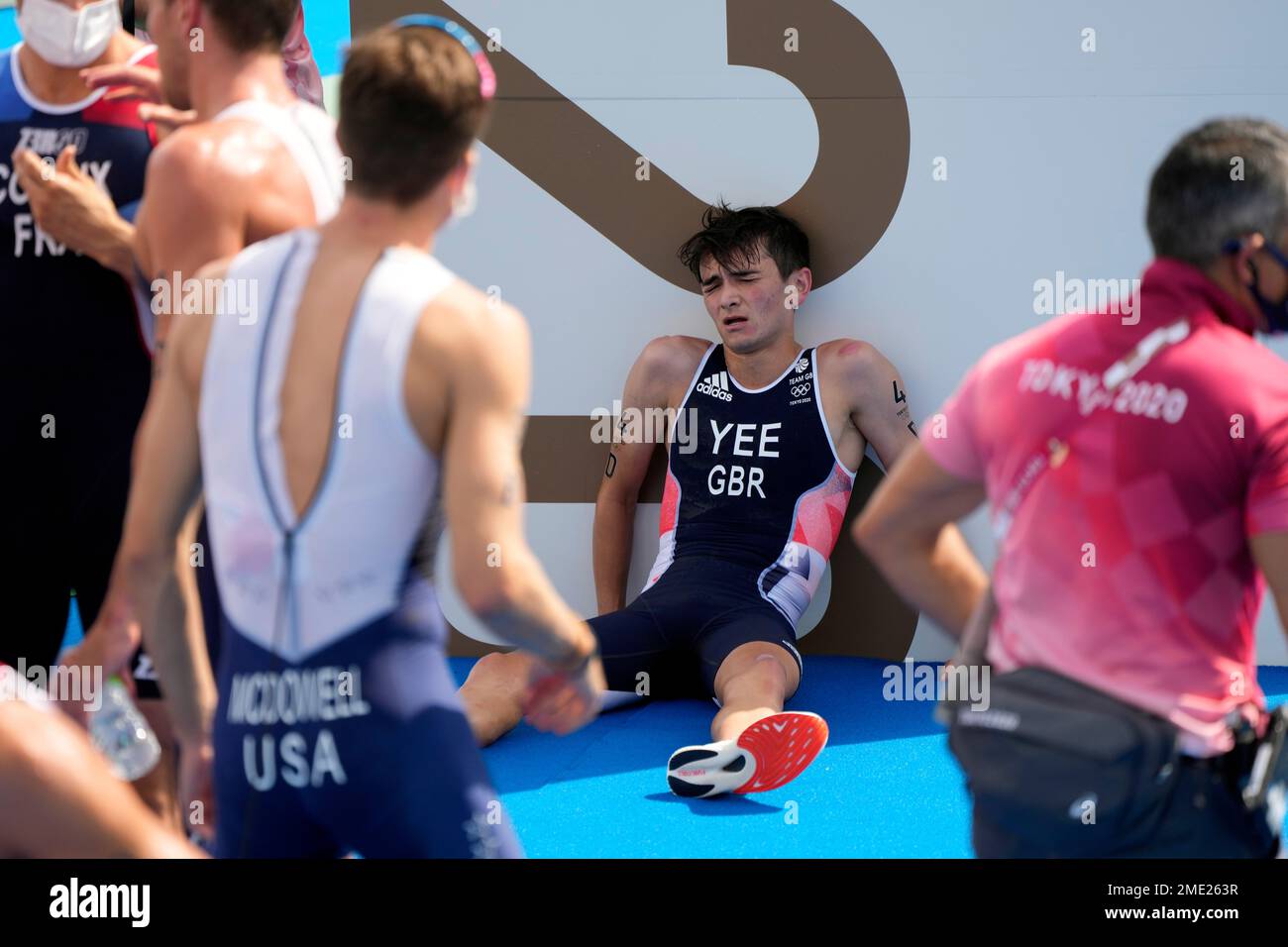 Alex Yee, of Britain, sits after winning the gold medal in the mixed ...