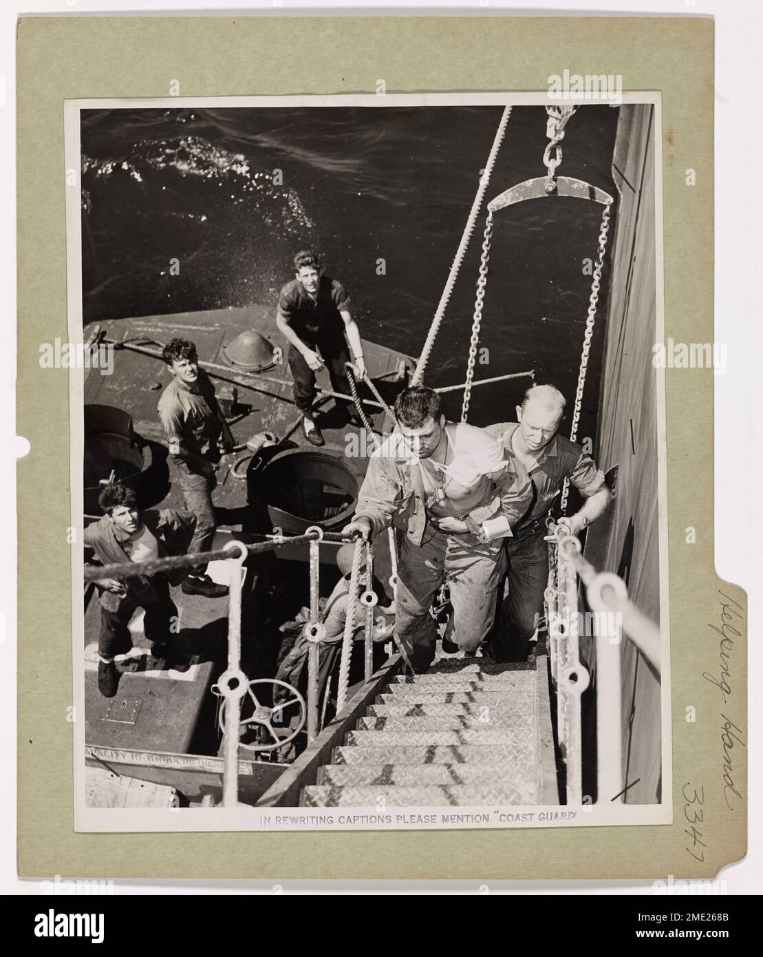 A Marine wounded at Eniwetok Atoll receives first aid from Pharmacist ...
