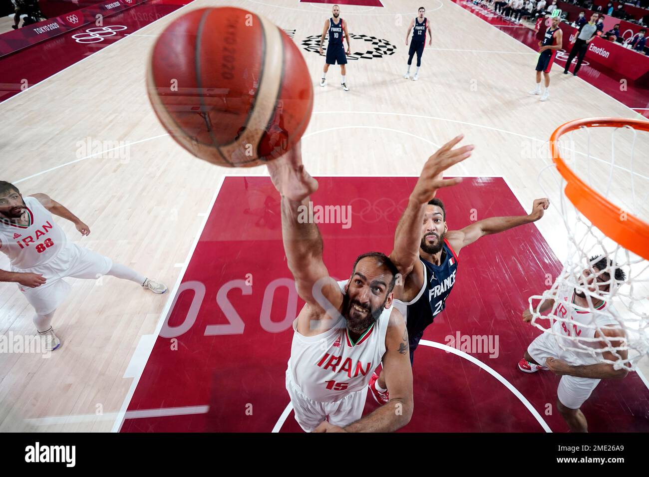 Iran's Hamed Haddadi (15) and France's Rudy Gobert (27) reach for a ...