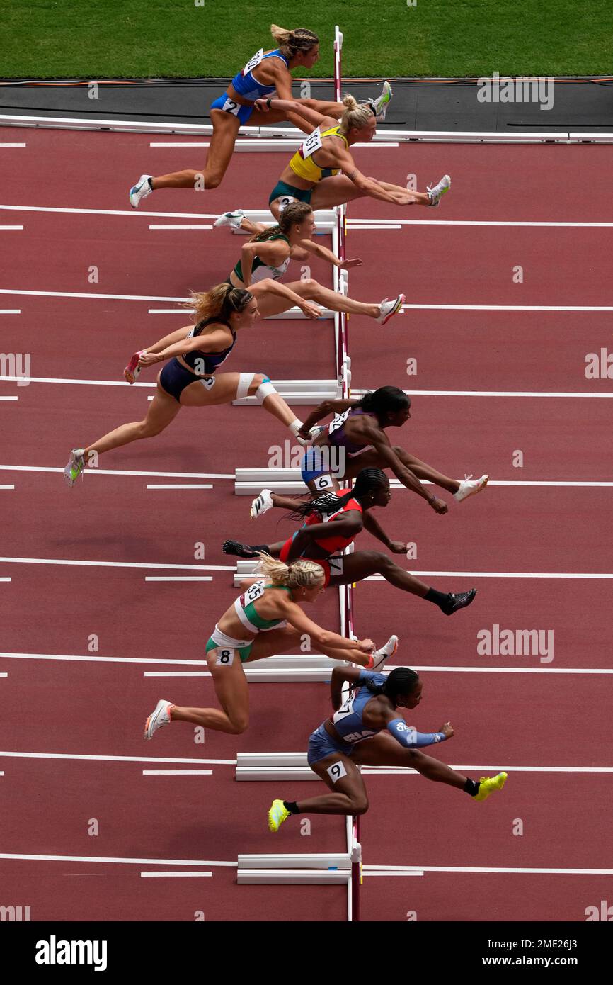 Runners compete in a heat in the women's 100-meter hurdles at the 2020 ...