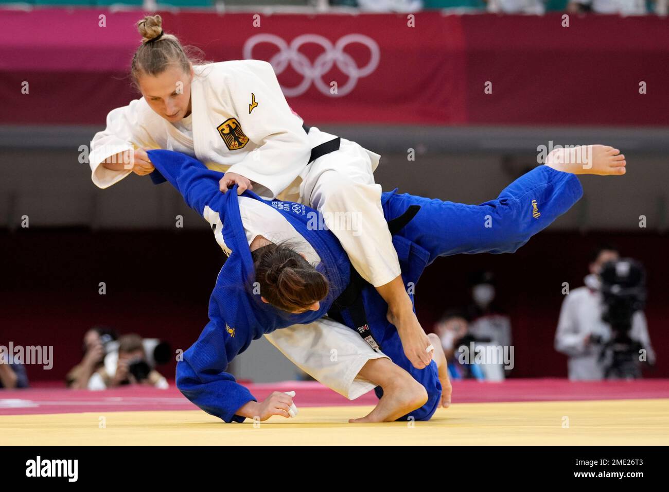 Martyna Trajdos of Germany, top, and Muna Dahouk of the Refugee Olympic ...