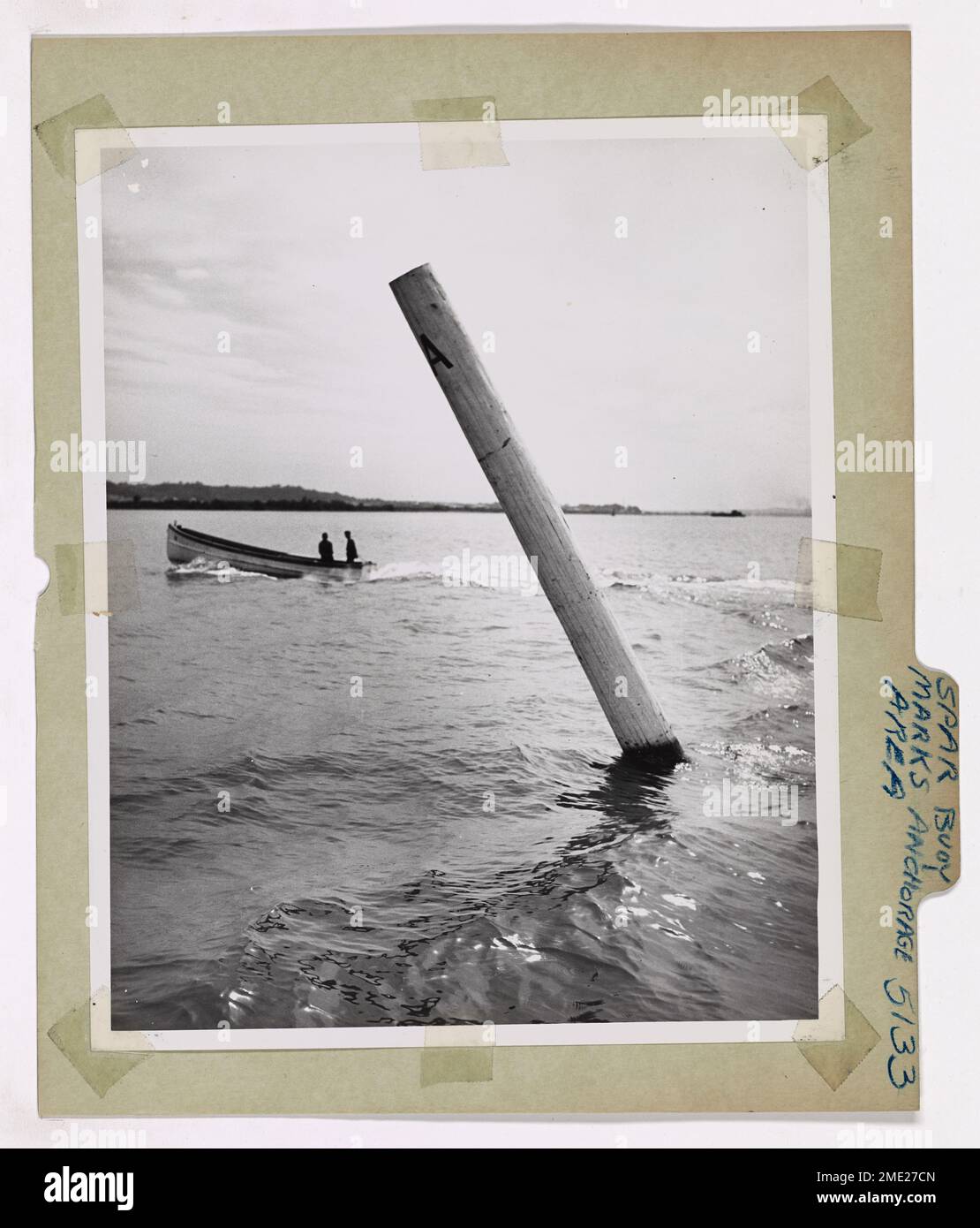A white spar buoy marks an anchorage area in the Potomac River. The ...